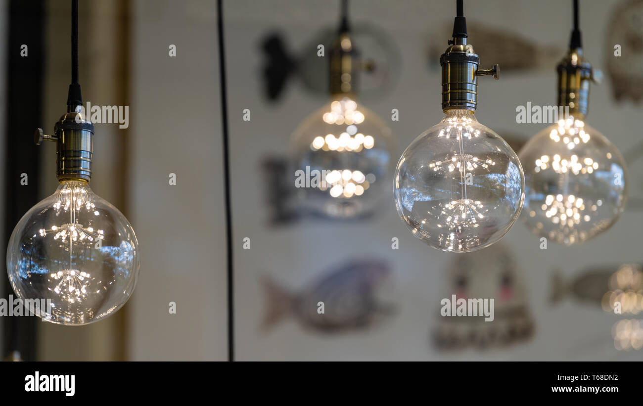 LED pendant lights with round glass balls, brass sockets, glowing ...