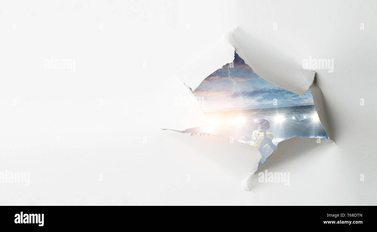 Paper torn hole effect with stadium view Stock Photo - Alamy