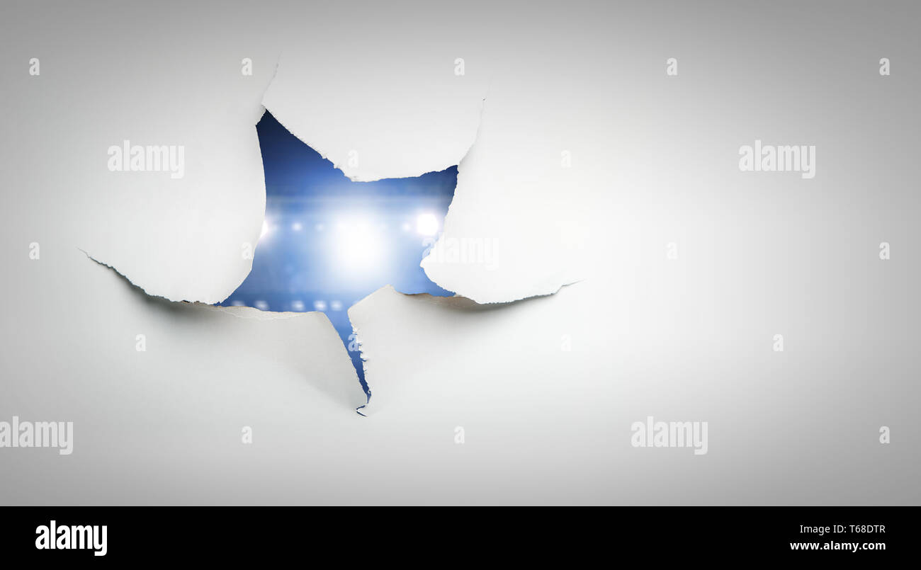 Paper torn hole effect with stadium view Stock Photo - Alamy