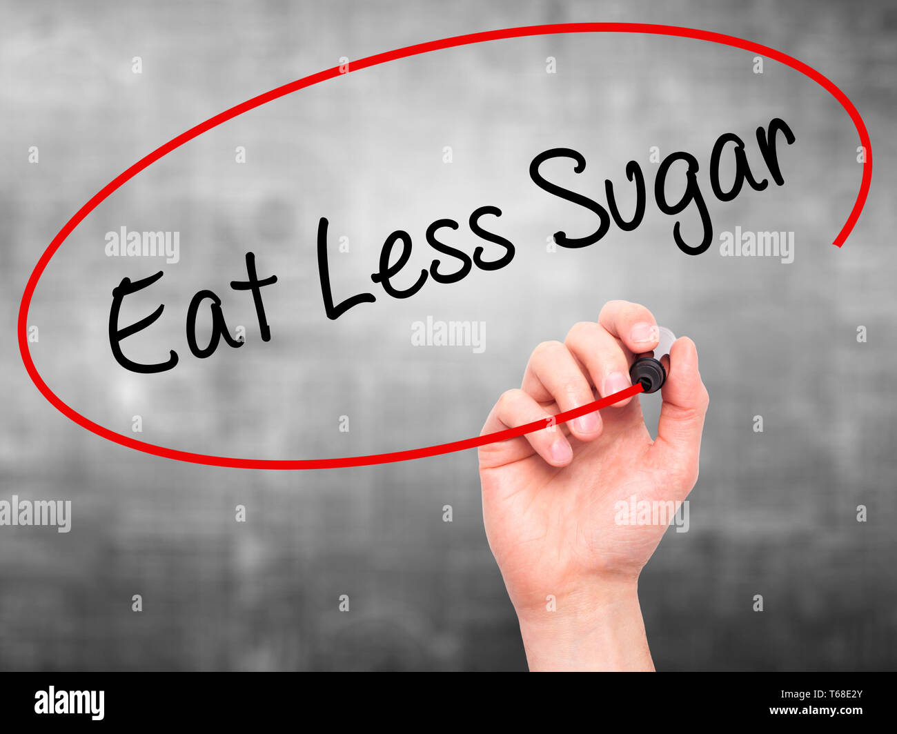 Man Hand writing Eat Less Sugar with black marker on visual screen ...