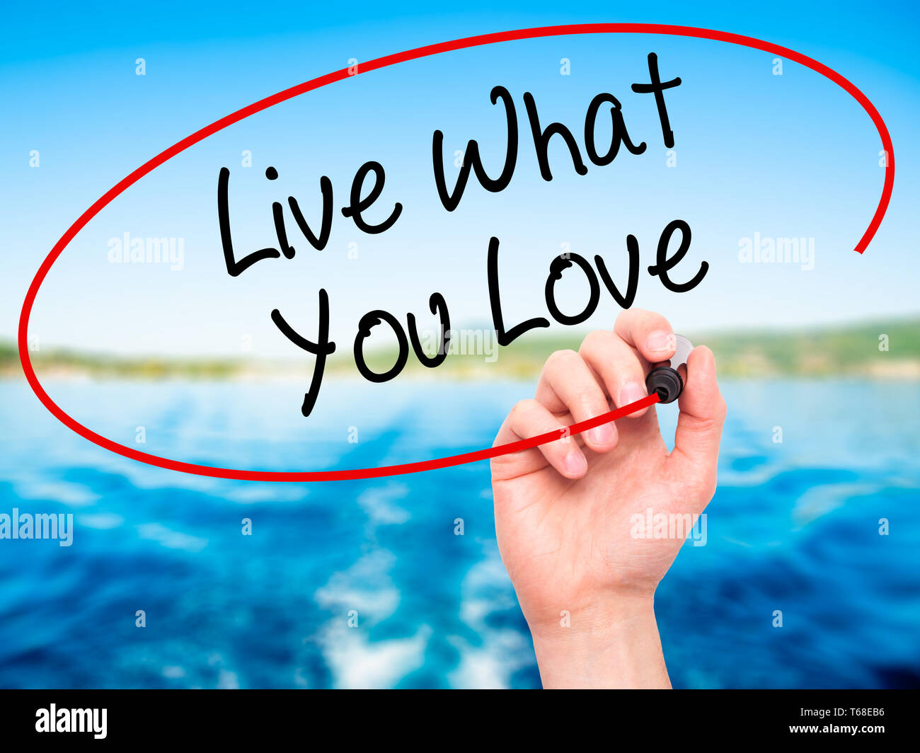 Man Hand writing Live What You Love with black marker on visual screen ...