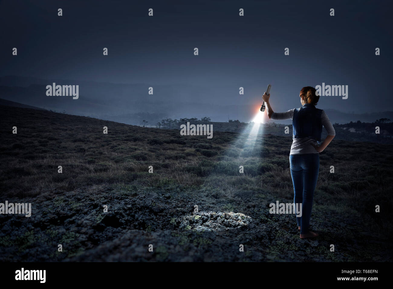Young woman holding a flashlight Stock Photo - Alamy