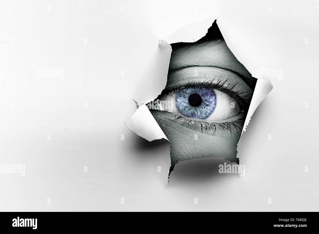 Eye looking through paper hi-res stock photography and images - Alamy