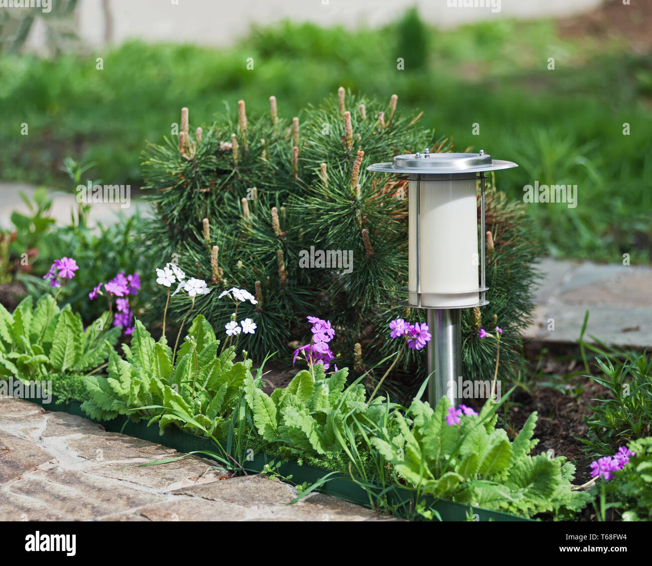 Solar-powered lamp on garden background Stock Photo - Alamy