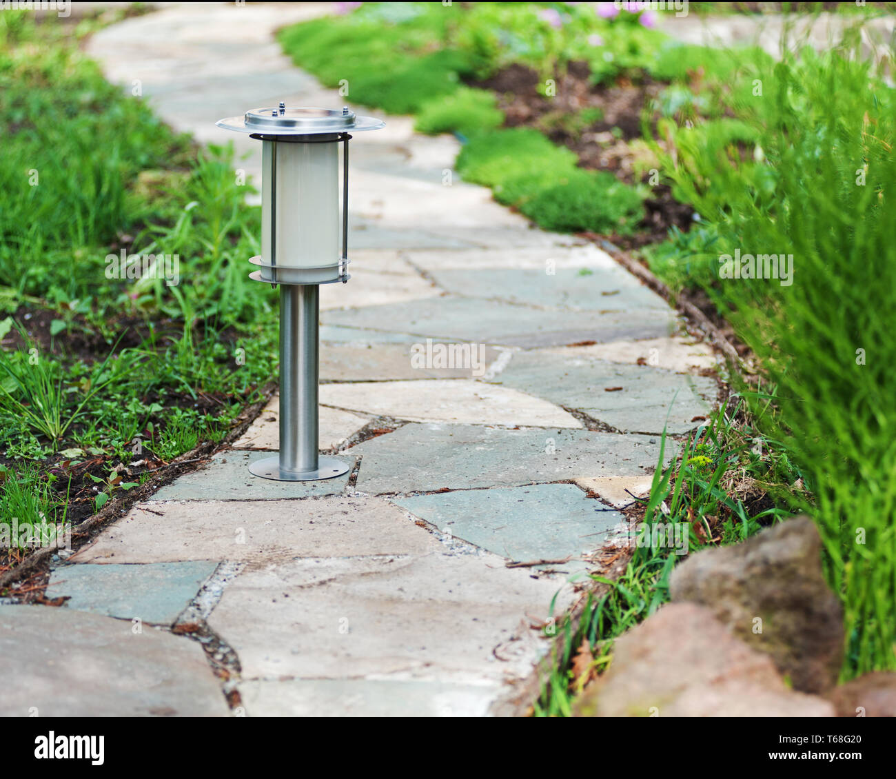 Solar-powered lamp on garden background Stock Photo - Alamy