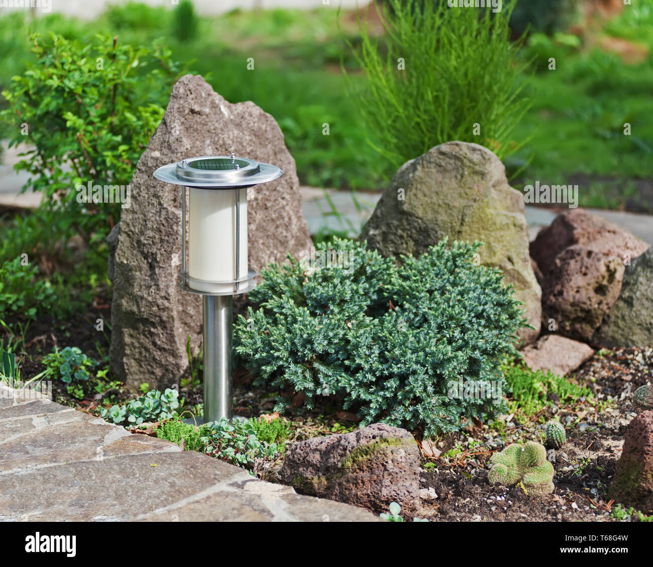 Solar-powered lamp on garden background Stock Photo - Alamy