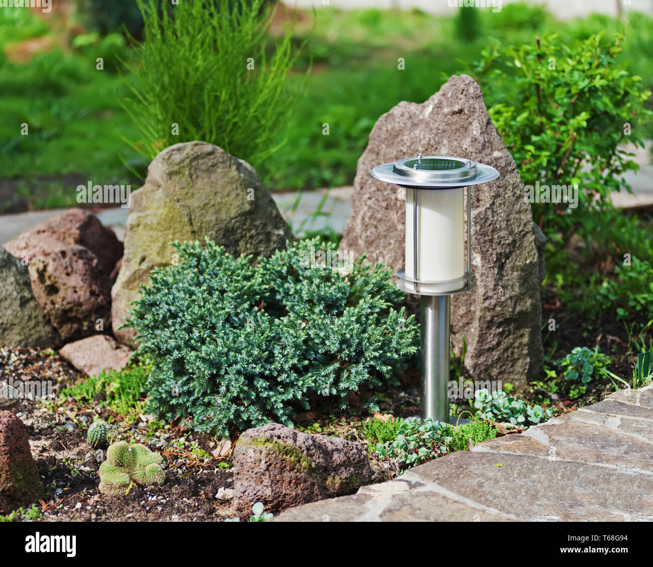 Solar-powered lamp on garden background Stock Photo - Alamy