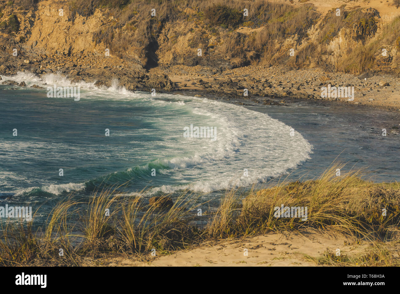 Two waves crashing on the beach in Almograve, Portugal Stock Photo - Alamy