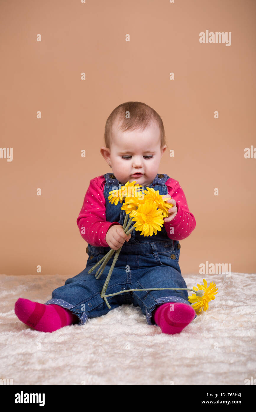 infant baby with yellow flowers Stock Photo - Alamy
