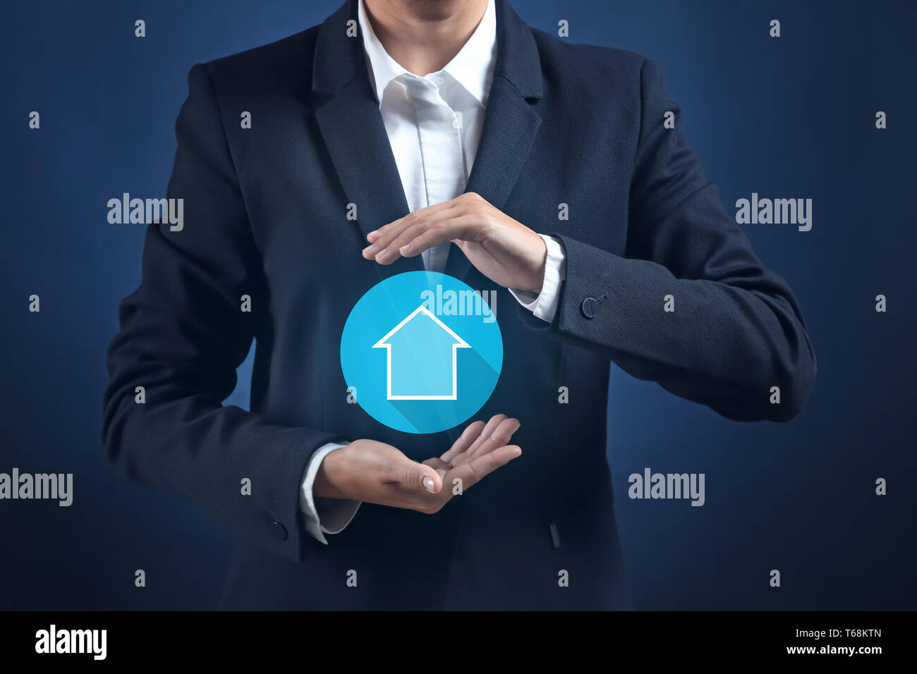 Businessman with icon of smart home automation on dark background Stock ...