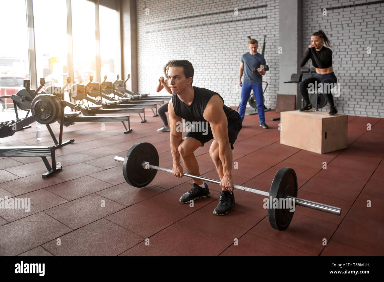 Group of people lifting heavy weight hi-res stock photography and ...