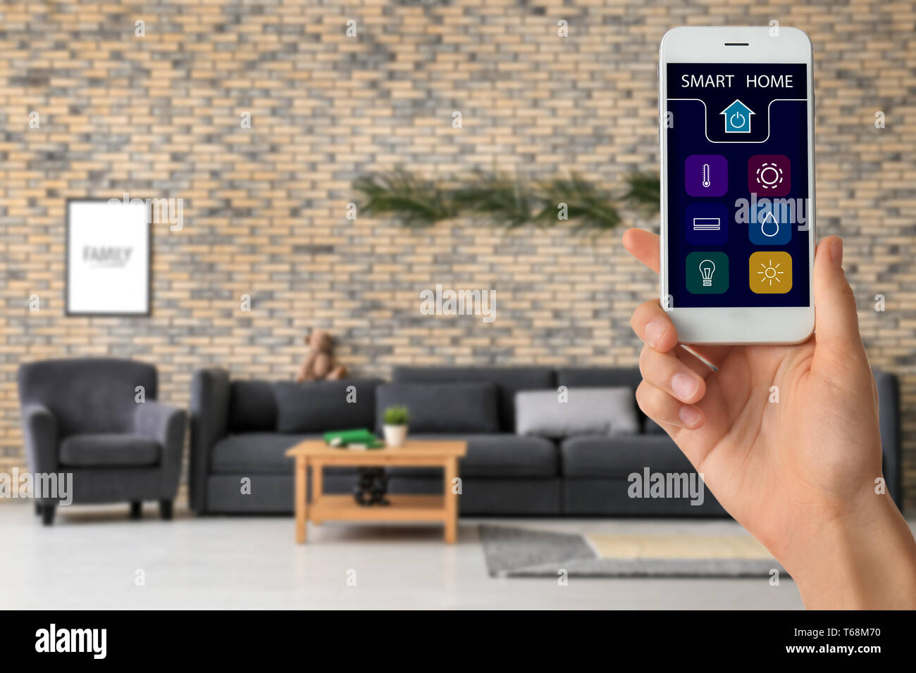 Woman holding mobile phone with application of smart home automation ...
