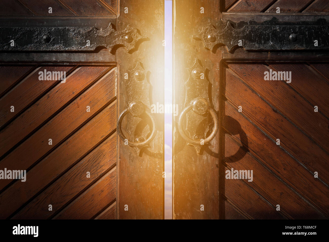 Magic light through open wooden door Stock Photo - Alamy