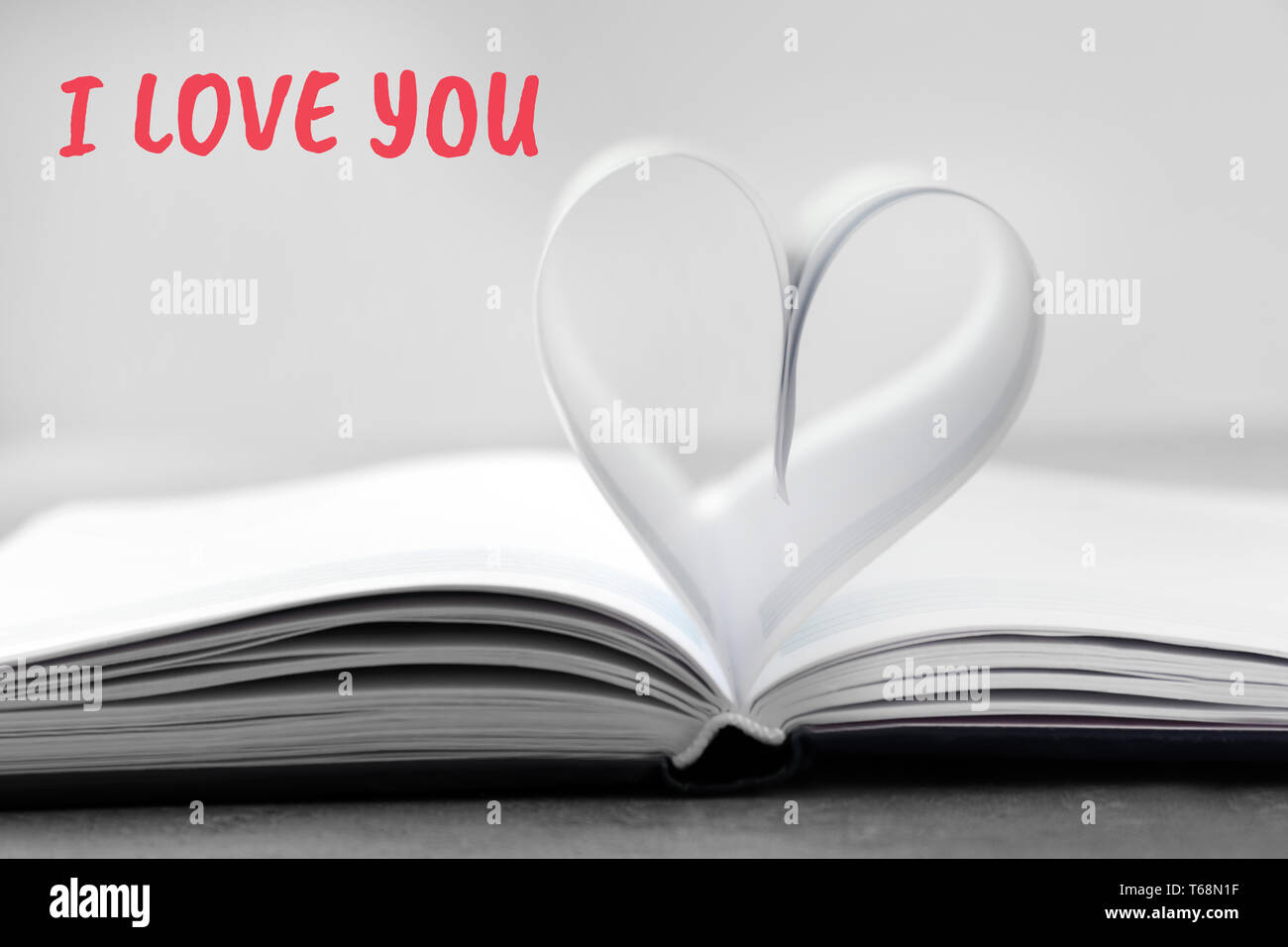 Heart made of paper sheets on book with text I LOVE YOU. Valentines Day ...