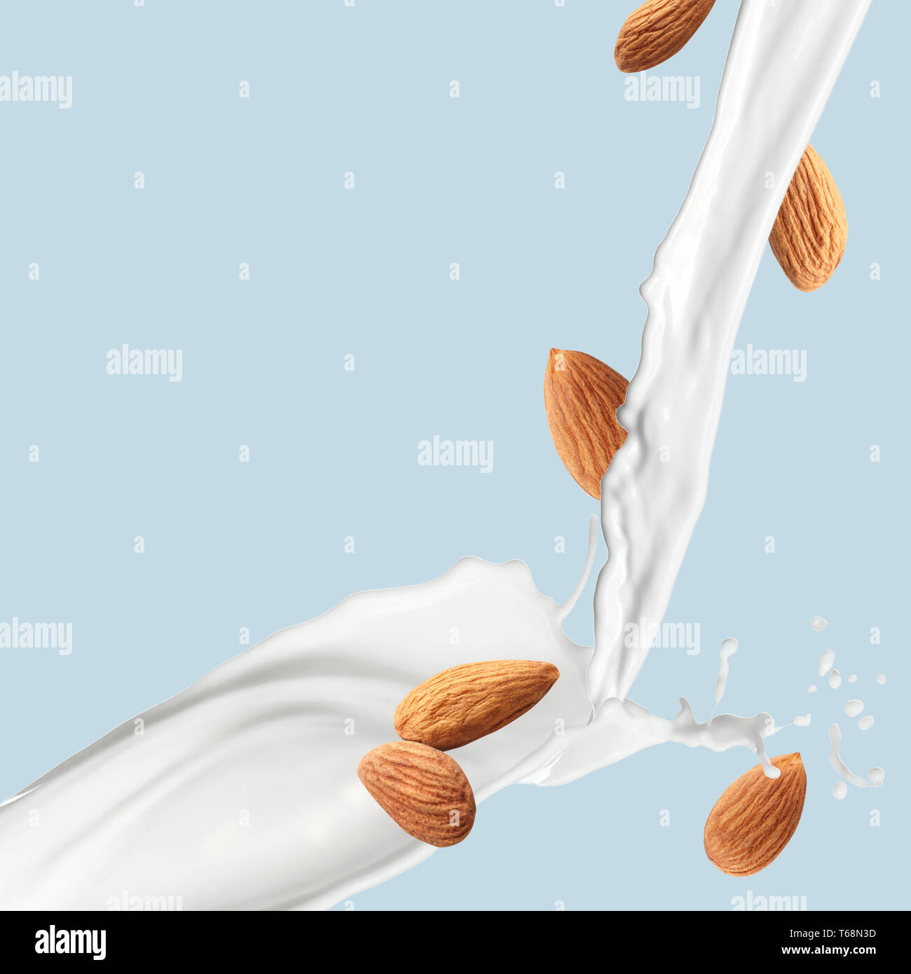 Splash of almond milk on light blue background Stock Photo - Alamy