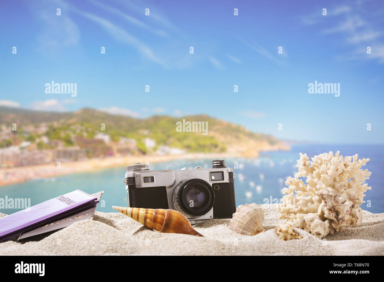 Photo camera with passports and seashells on sand beach at resort Stock ...