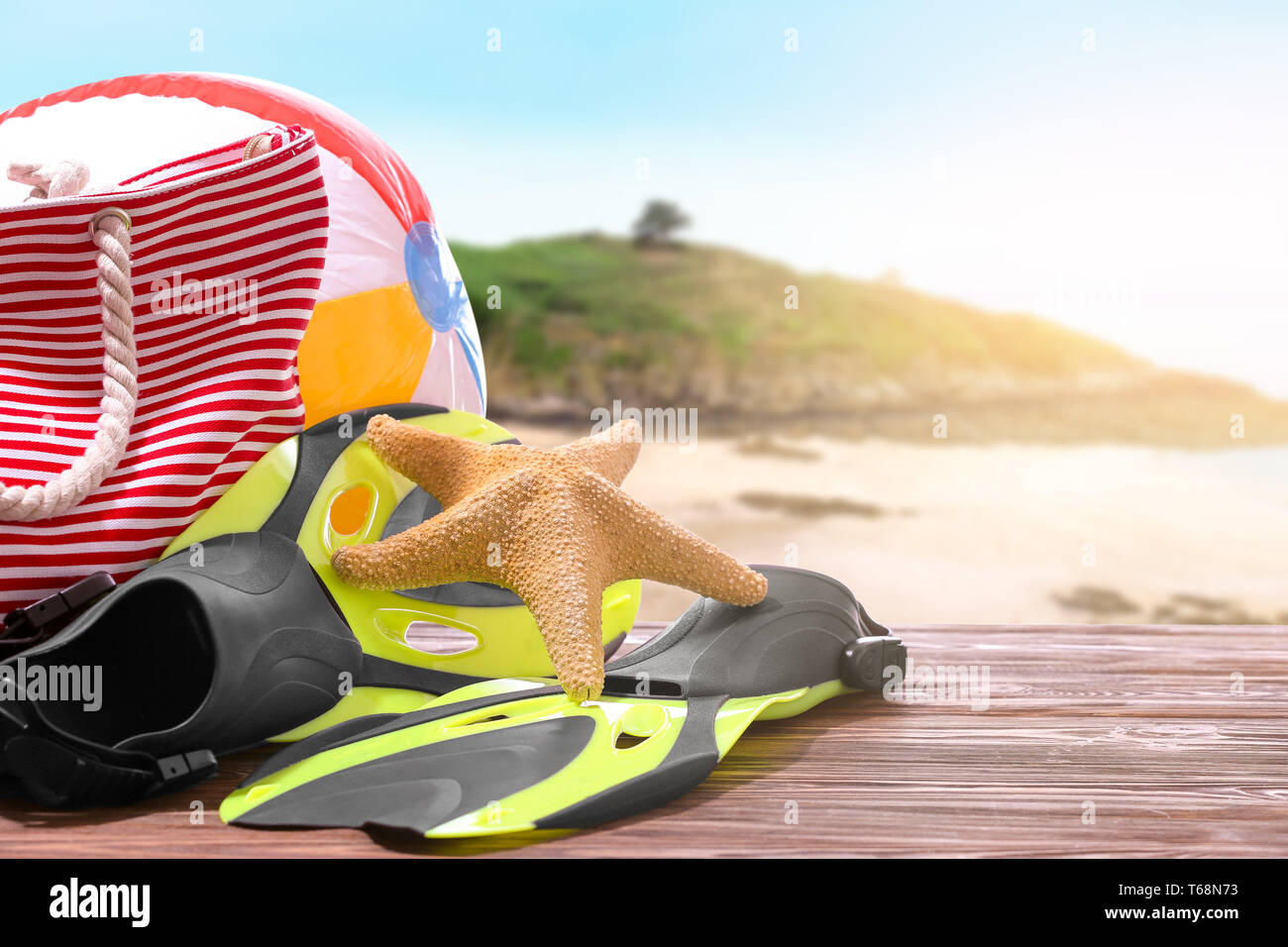 Set of beach items on wooden table at resort Stock Photo - Alamy