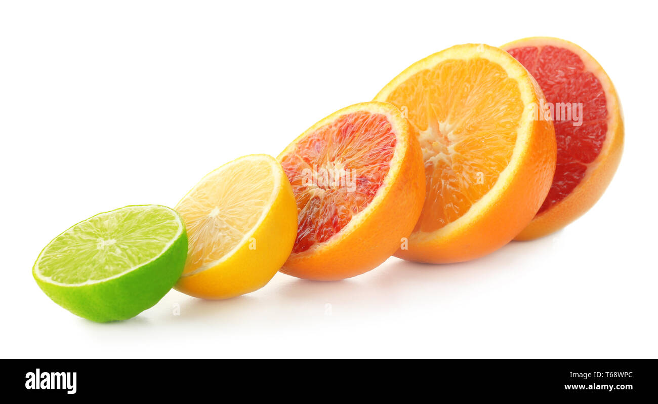 Tasty cut citrus fruits on white background Stock Photo - Alamy