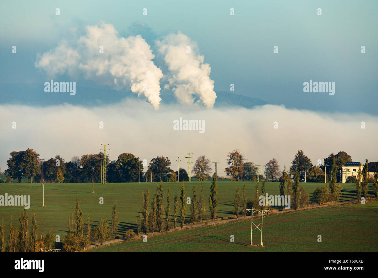 smoking chimneys in from factory hidden in mist Stock Photo - Alamy