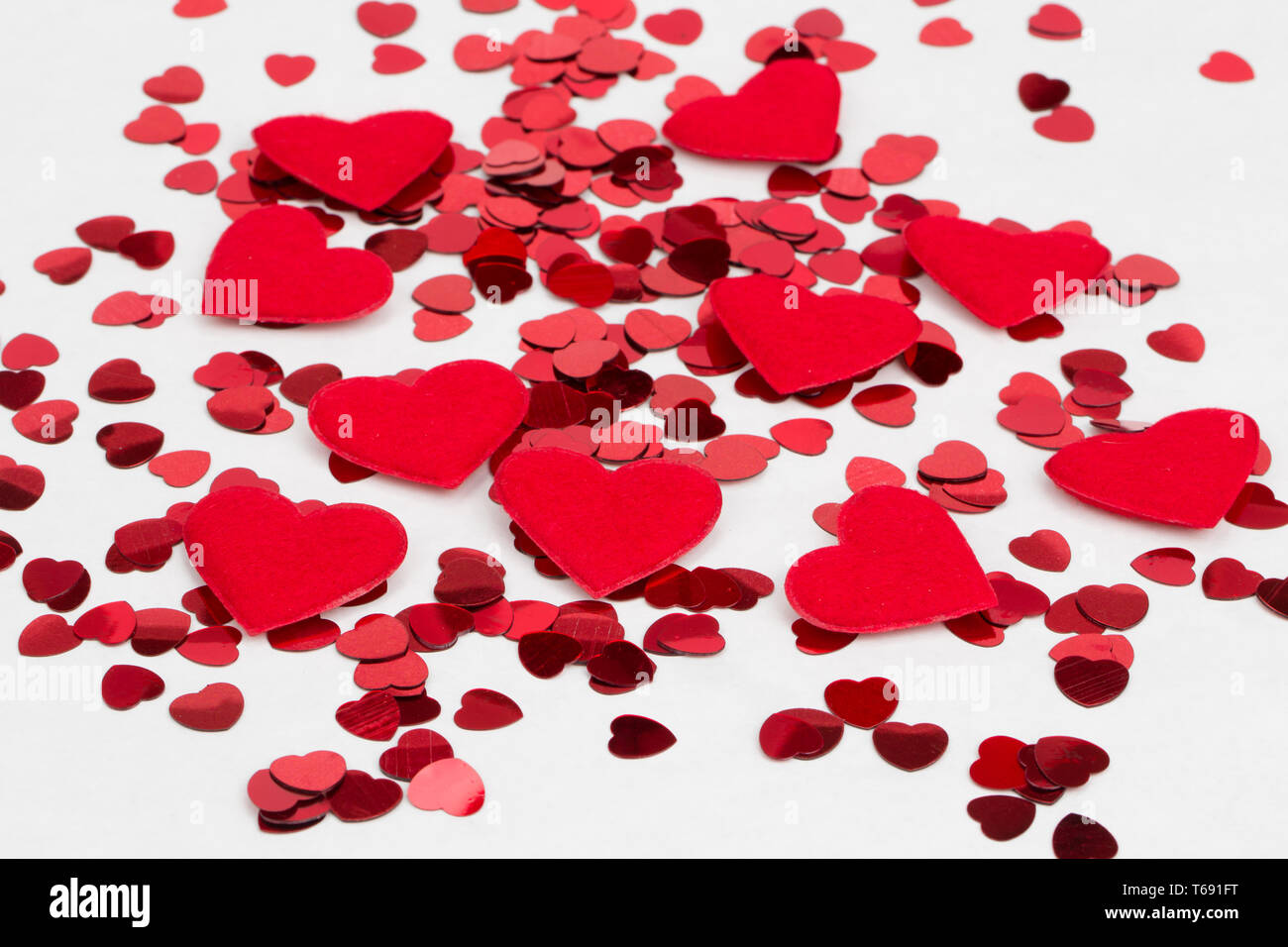 Red hearts confetti and fabric heart Stock Photo - Alamy