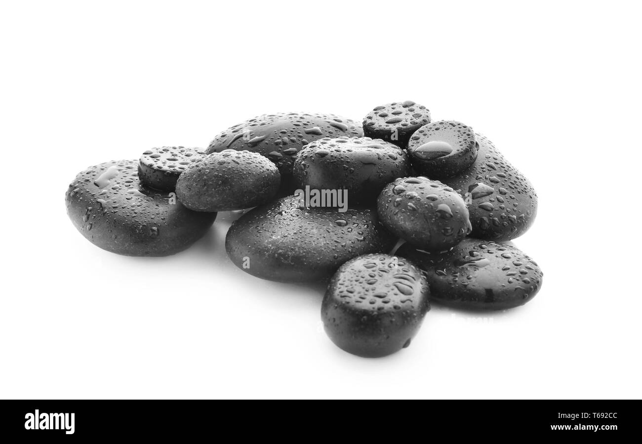 Spa stones with drops of water on white background Stock Photo - Alamy
