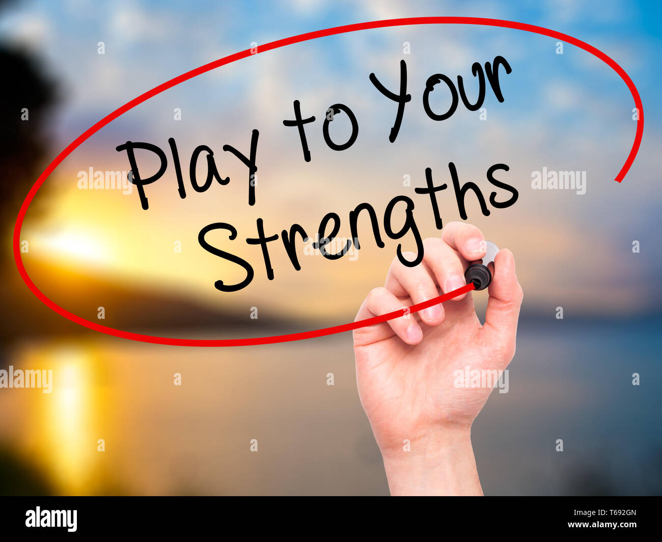 Man Hand writing Play to Your Strengths with black marker on visual ...