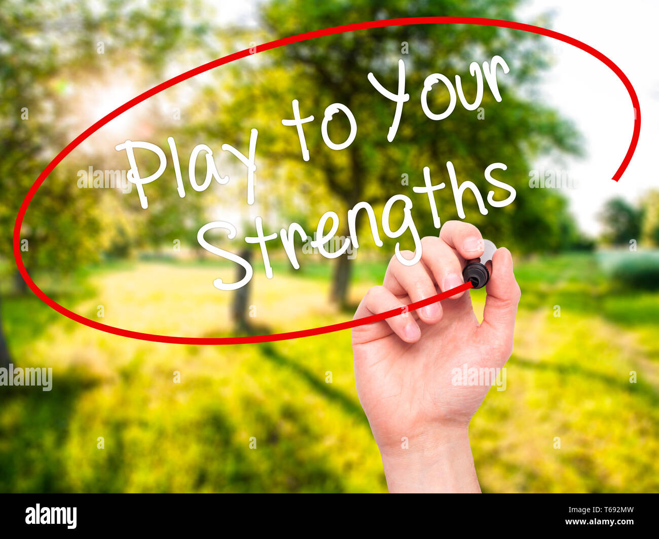 Man Hand writing Play to Your Strengths with black marker on visual ...