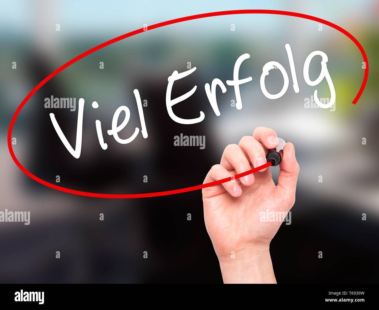 Man Hand writing Viel Erfolg (Much Success In German) with black marker ...