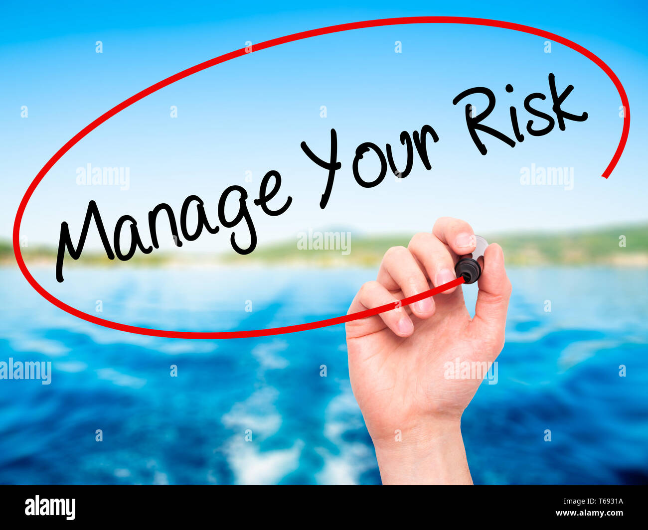Man Hand writing Manage your Risk with black marker on visual screen ...