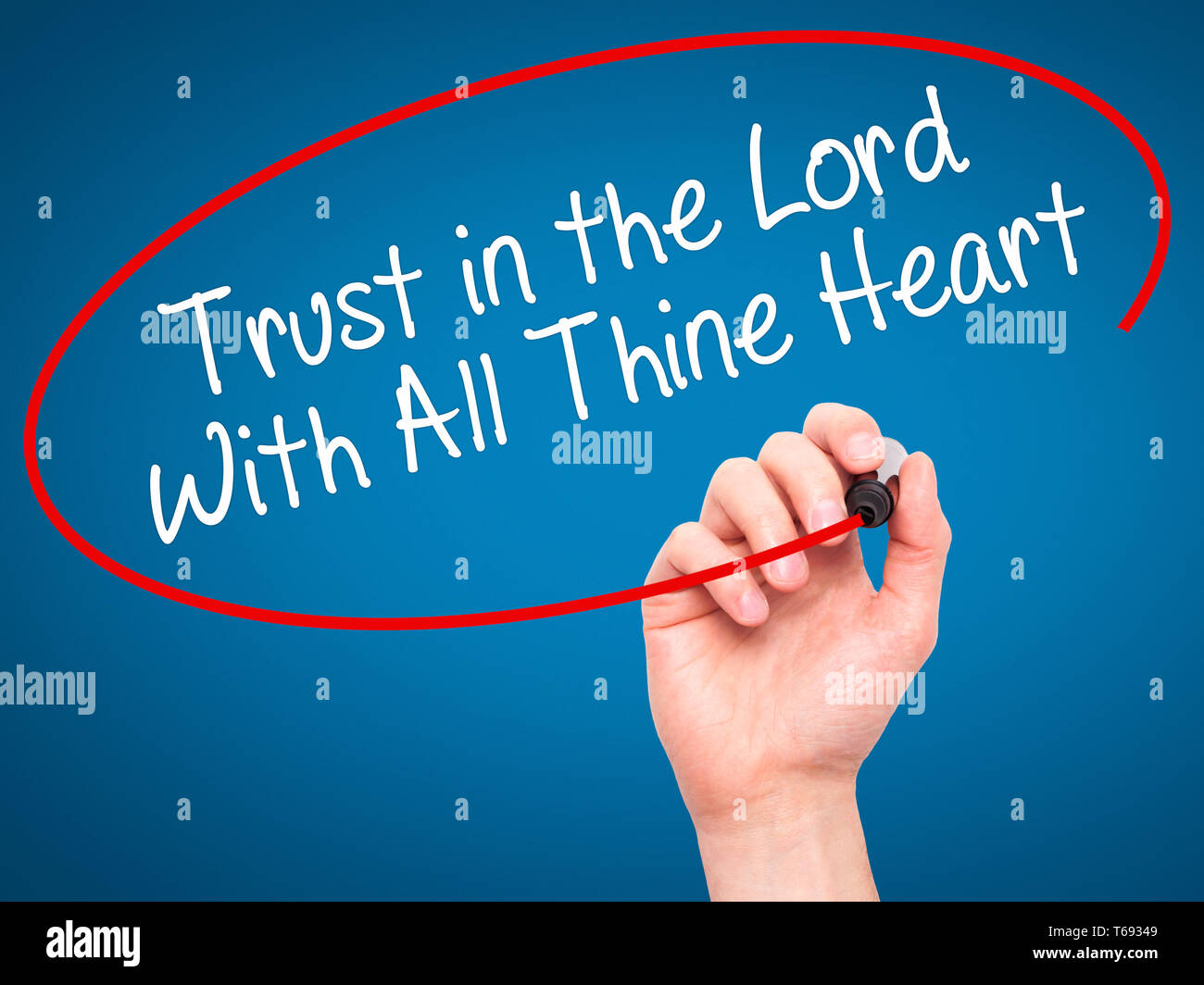 Man Hand writing Trust in the Lord With All Thine Heart with black ...