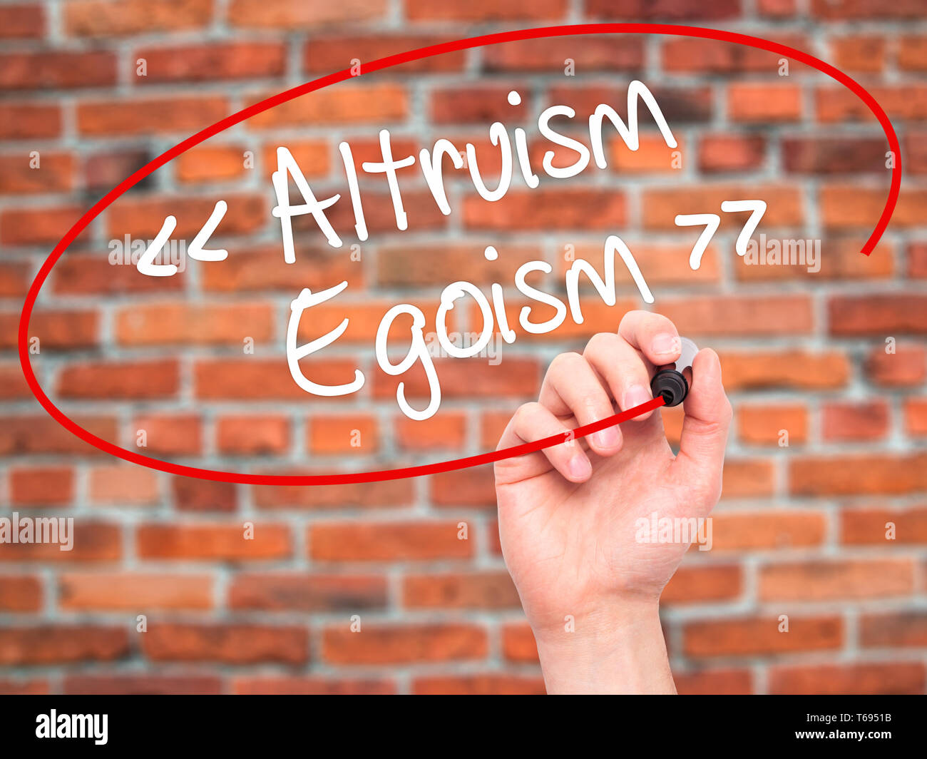 Man Hand writing Altruism - Egoism with black marker on visual screen ...