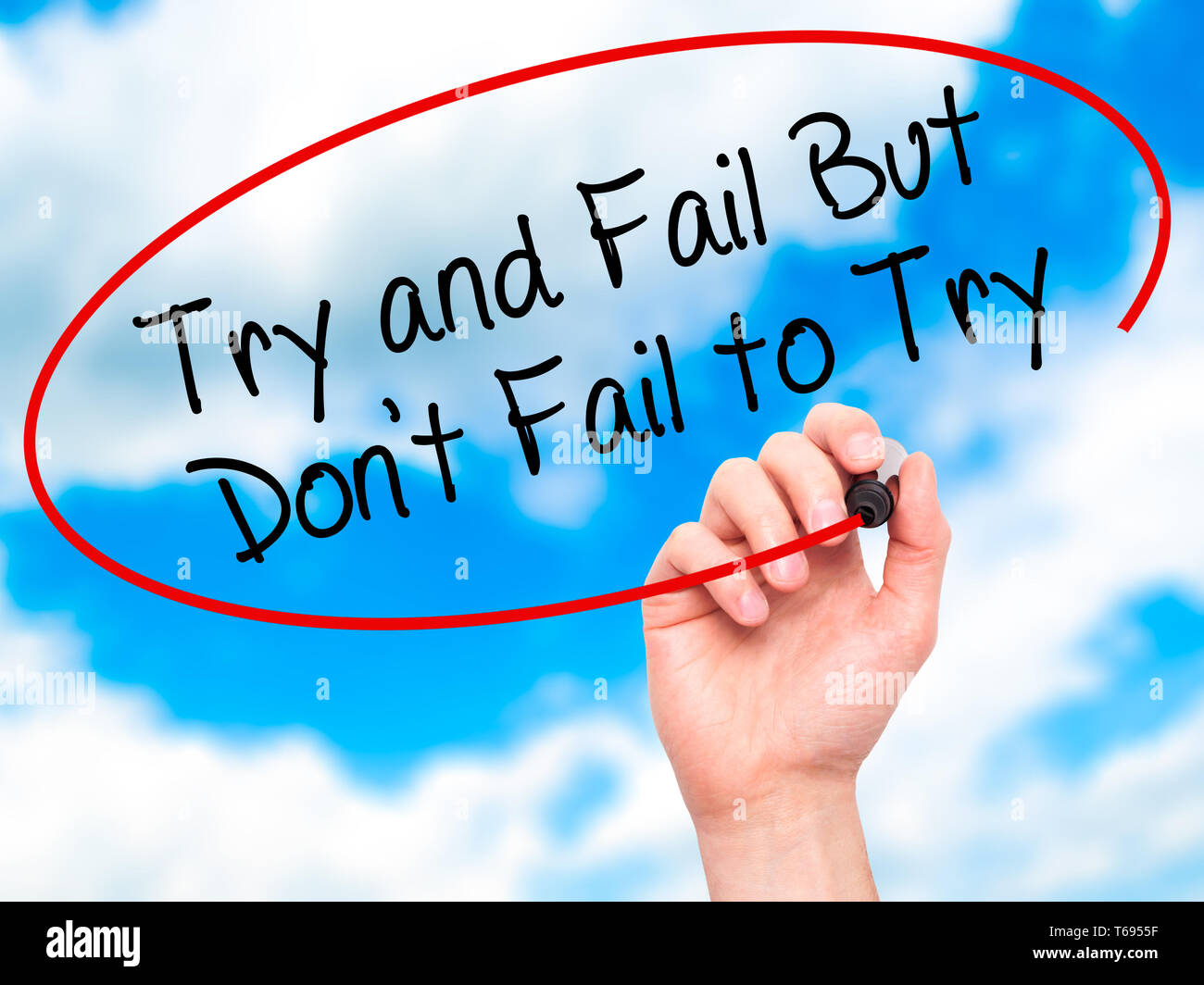 Man Hand writing Try and Fail But Don't Fail to Try with black marker ...