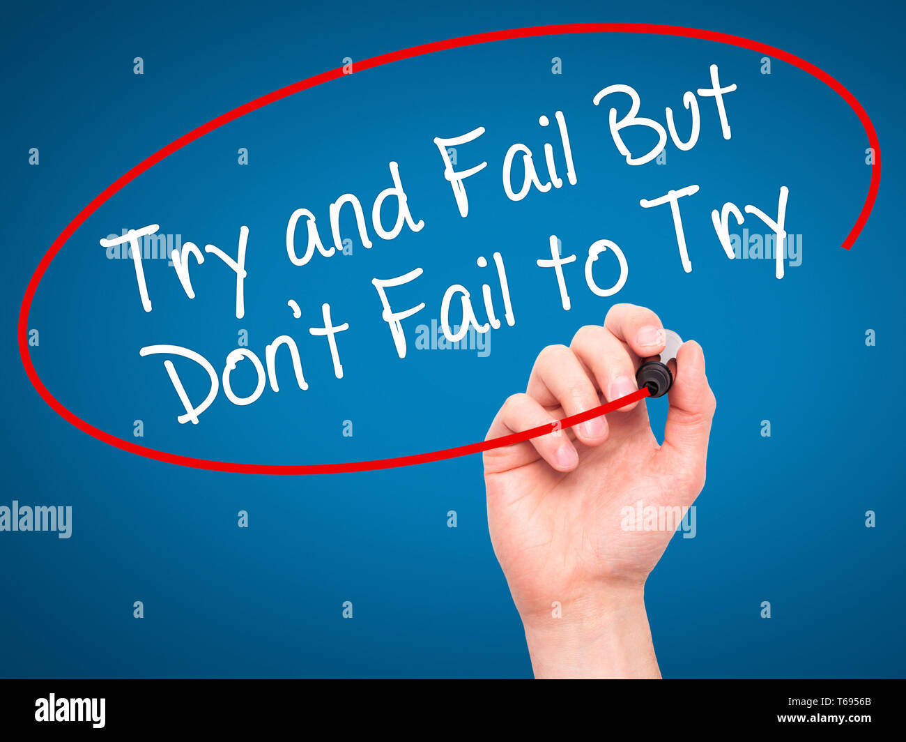 Man Hand writing Try and Fail But Don't Fail to Try with black marker ...