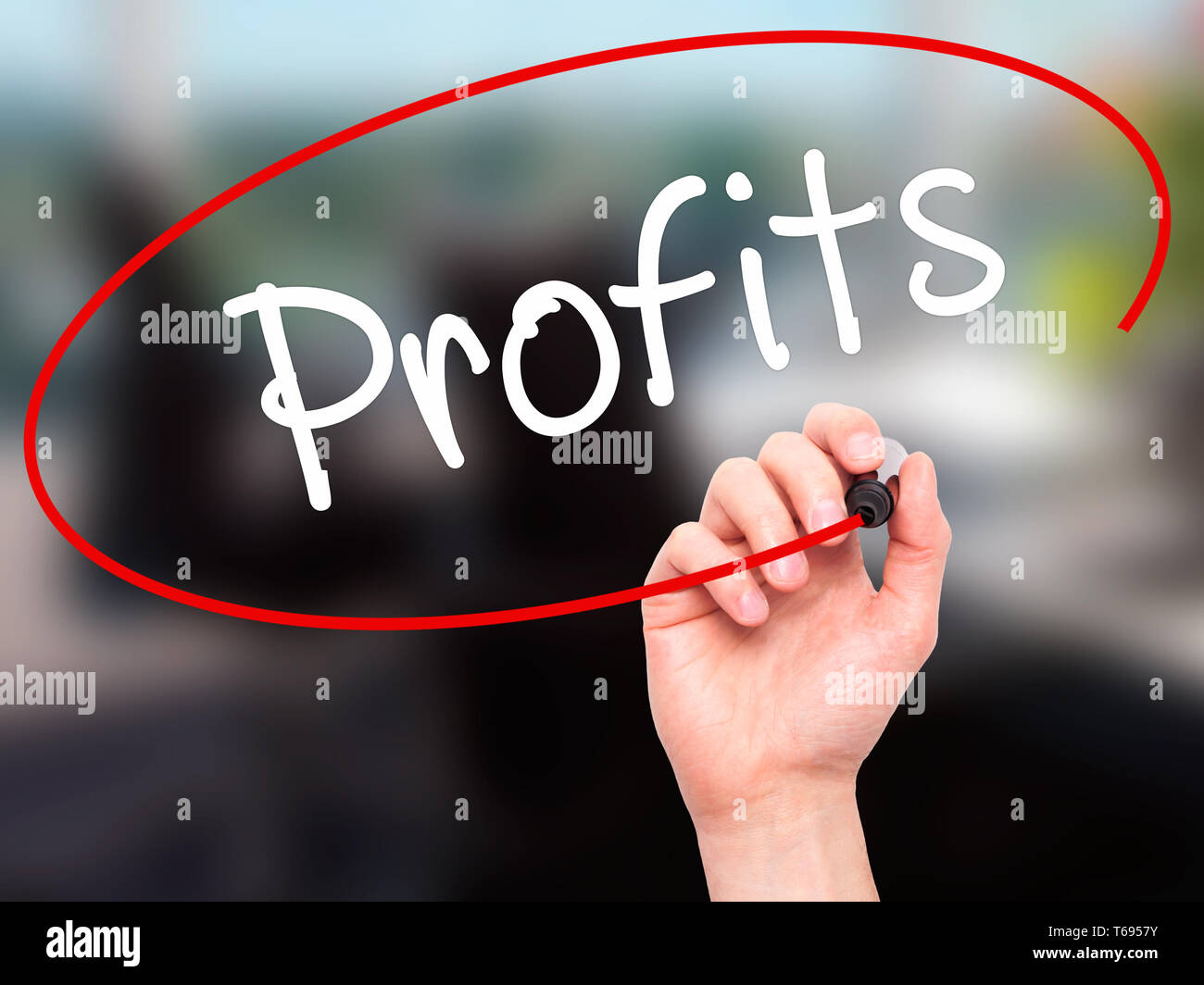 Man Hand writing Profits with black marker on visual screen Stock Photo ...