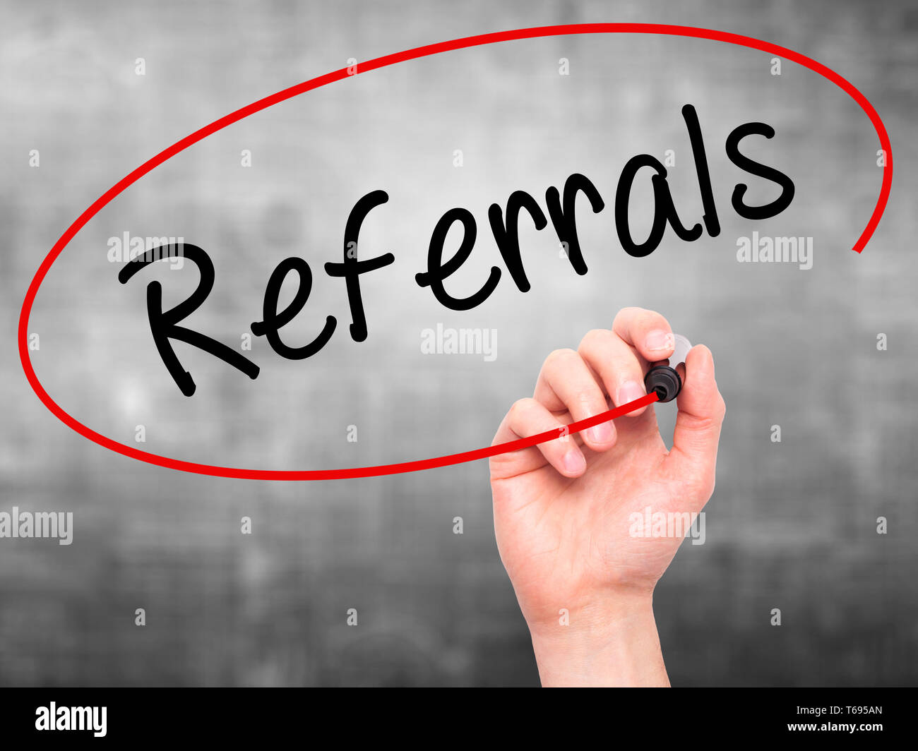 Man Hand writing Referrals with black marker on visual screen Stock ...