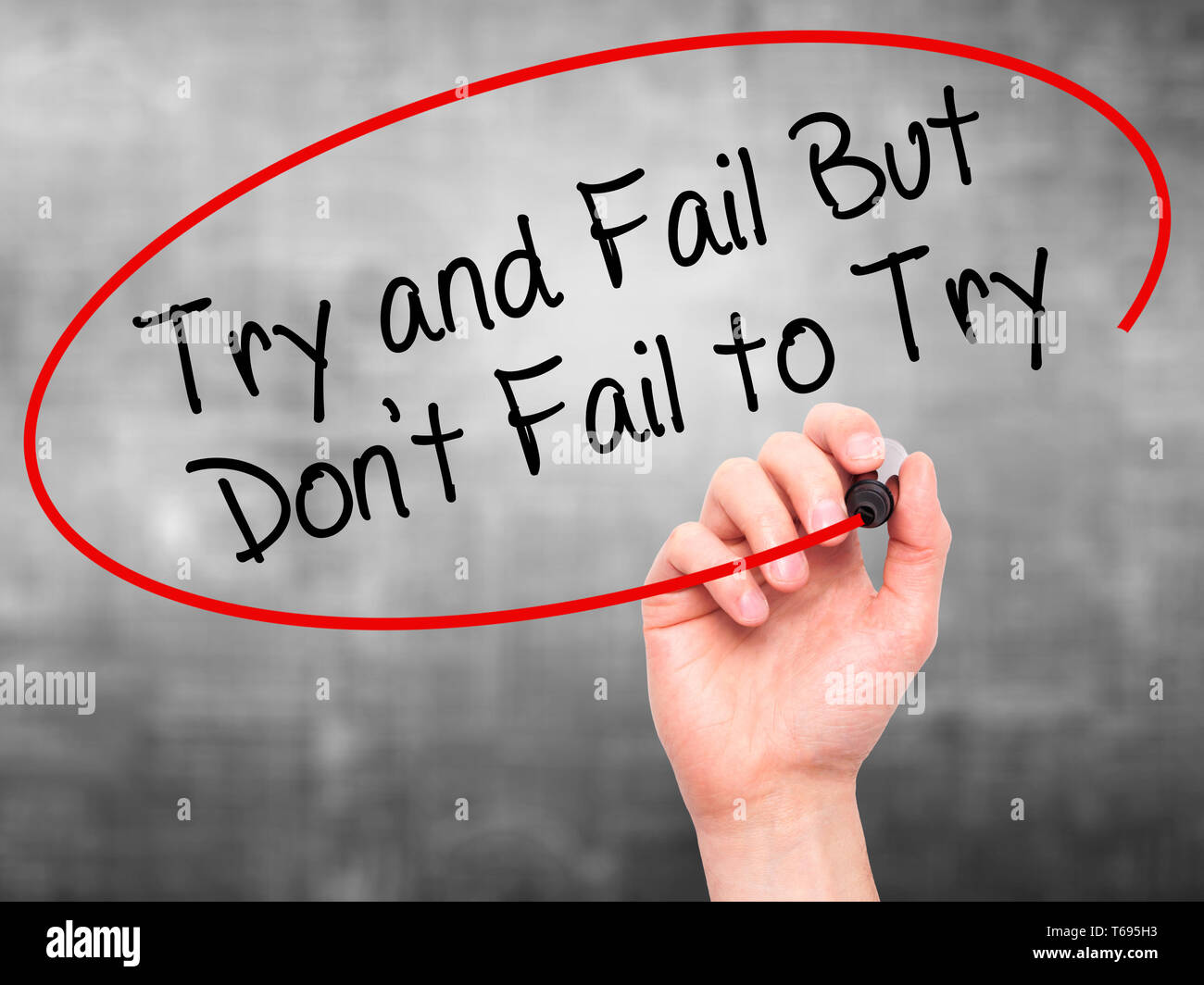 Man Hand writing Try and Fail But Don't Fail to Try with black marker ...