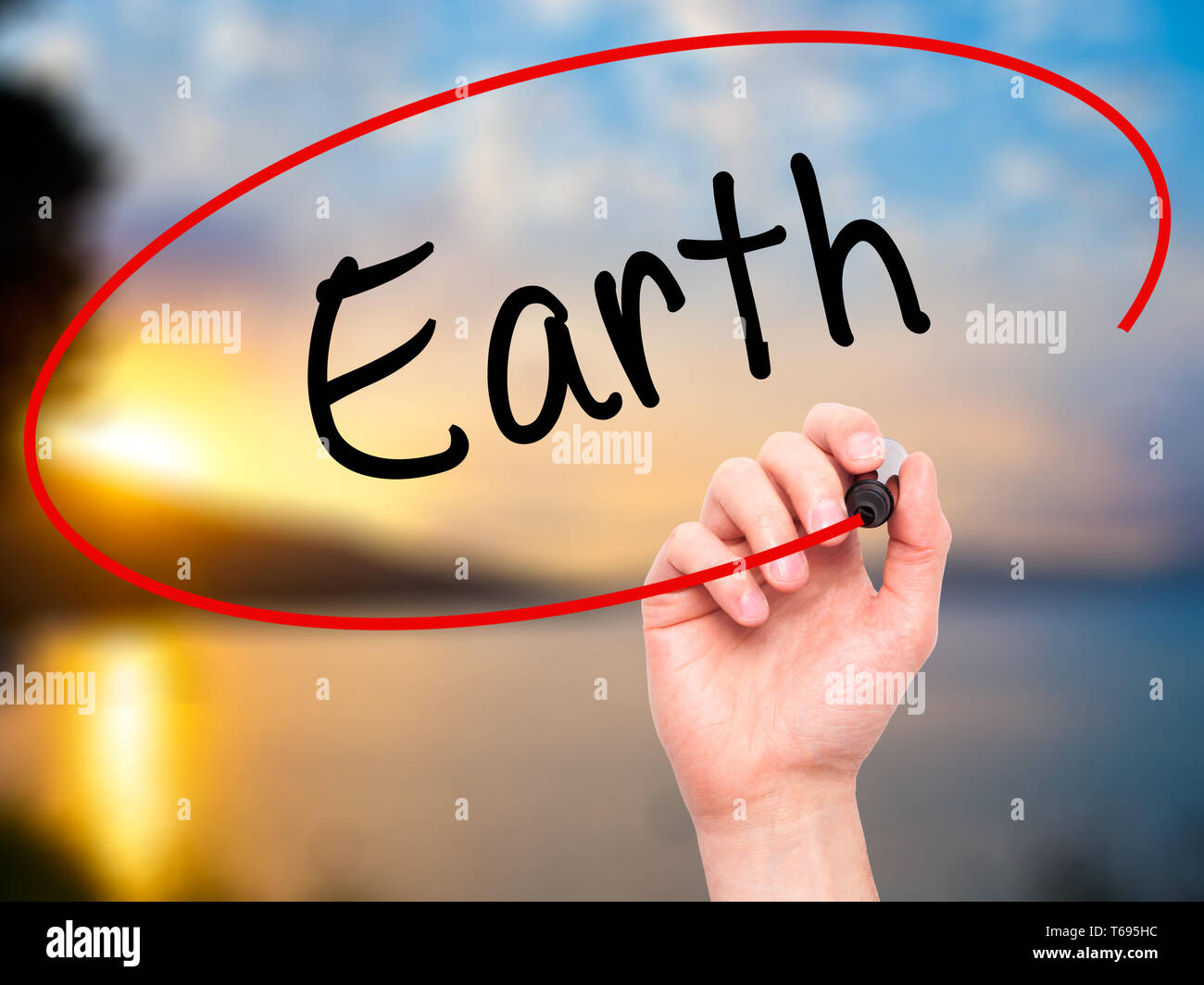 Man Hand writing Earth with black marker on visual screen Stock Photo ...