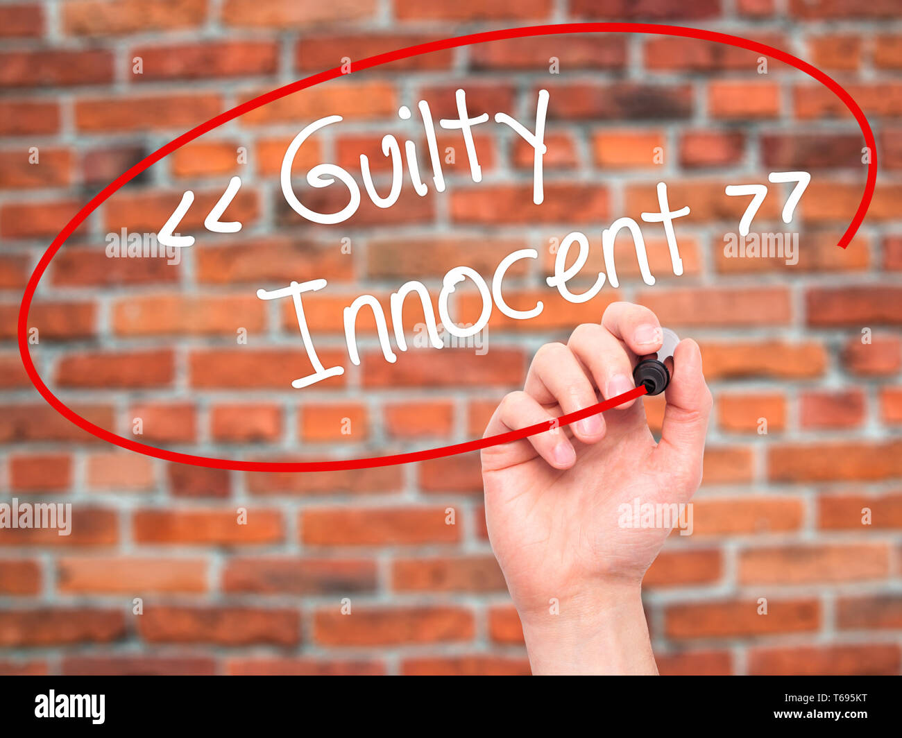 Man Hand writing Guilty - Innocent with black marker on visual screen ...