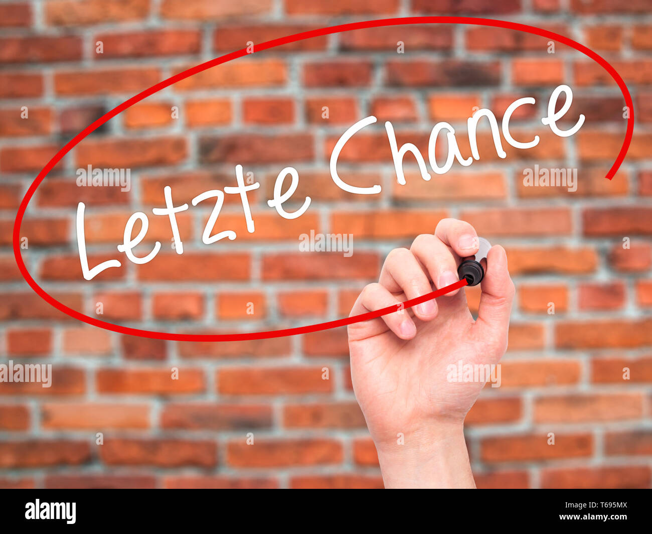 Man Hand writing Letzte Chance (Last Chance in German) with black ...