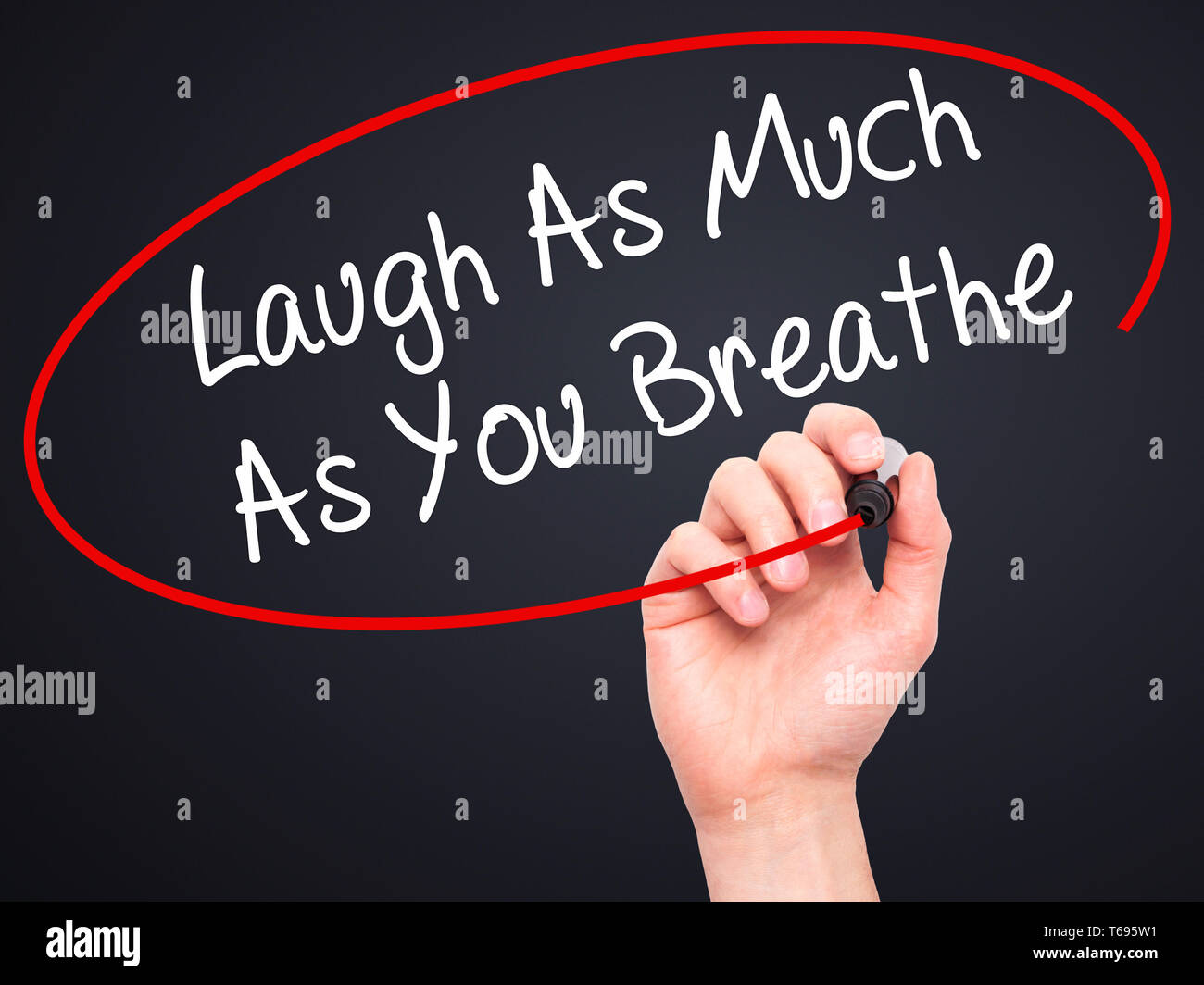 Man Hand writing Laugh As Much As You Breathe with black marker on ...