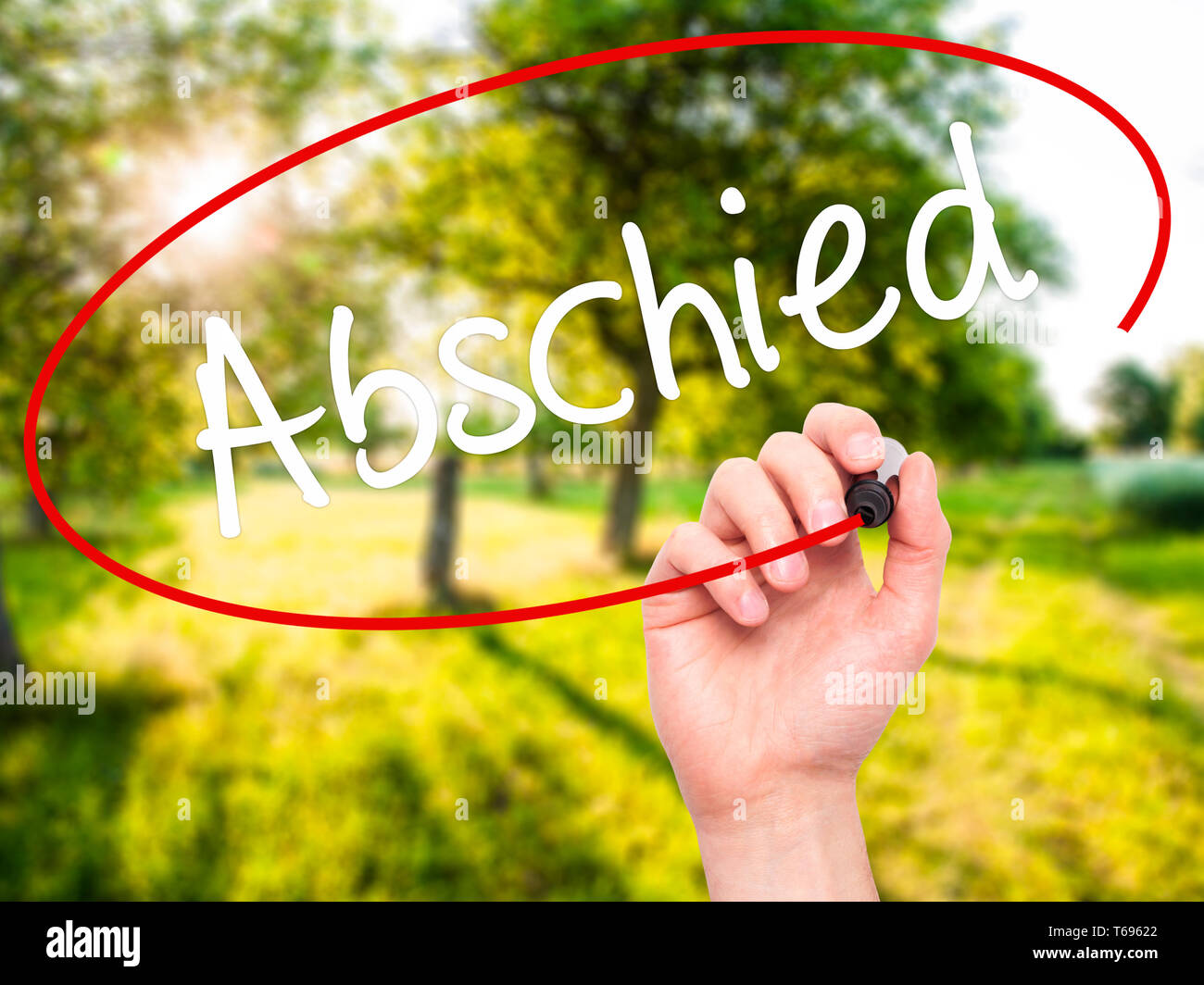 Man Hand writing Abschied (Farewell in German) with black marker on ...
