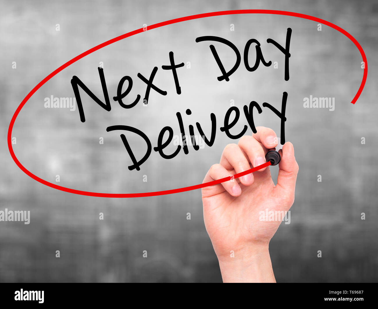 Man Hand writing Next Day Delivery with black marker on visual screen ...