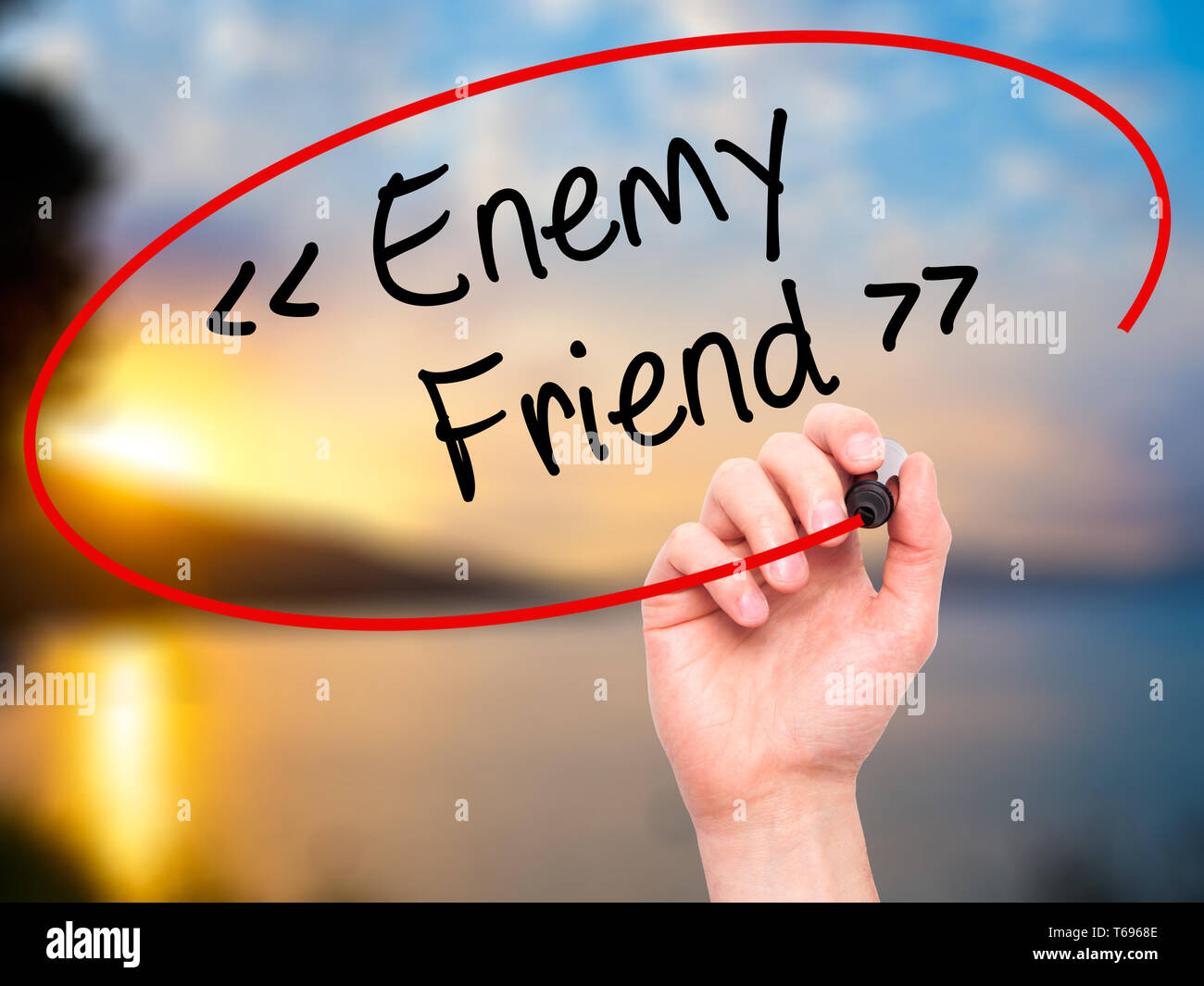 Man Hand writing Enemy - Friend with black marker on visual screen ...