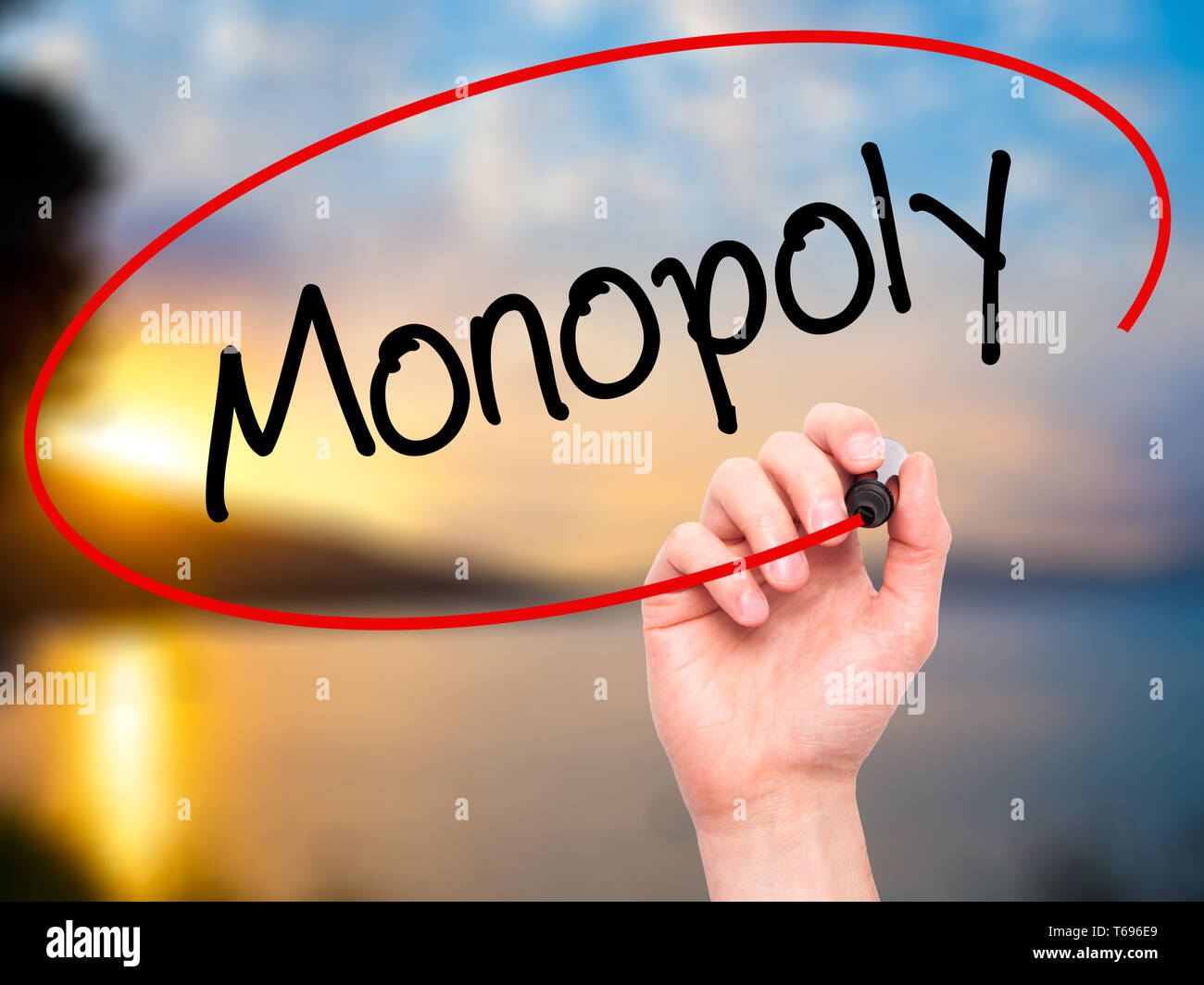 Man Hand writing Monopoly with black marker on visual screen Stock ...