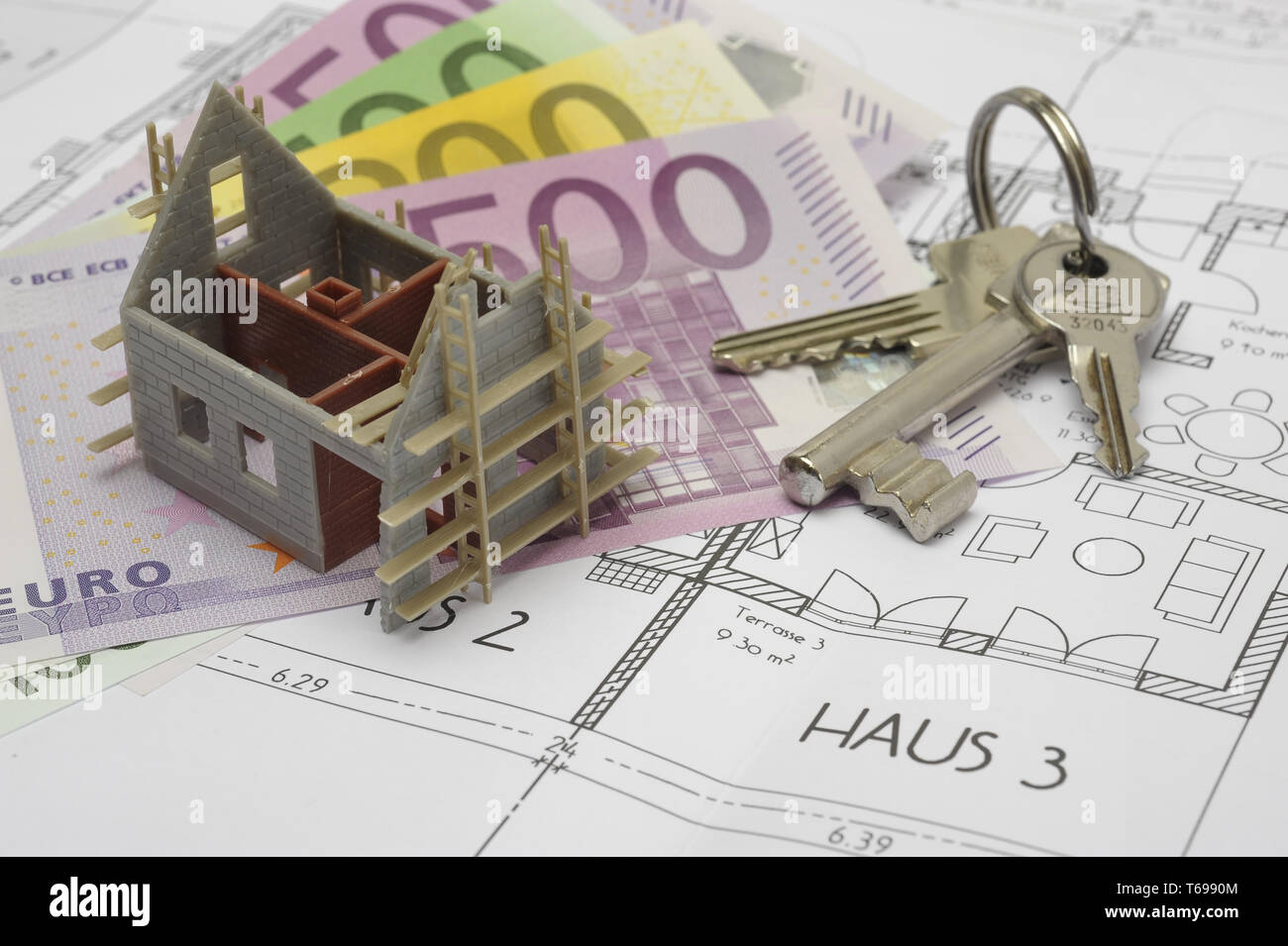 Model house on architectural plan with euro banknotes and key Stock ...