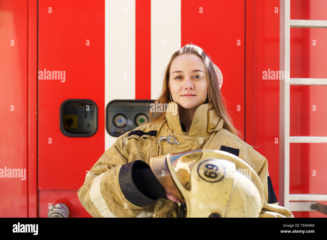 Photo of fire girl standing at fire truck Stock Photo - Alamy