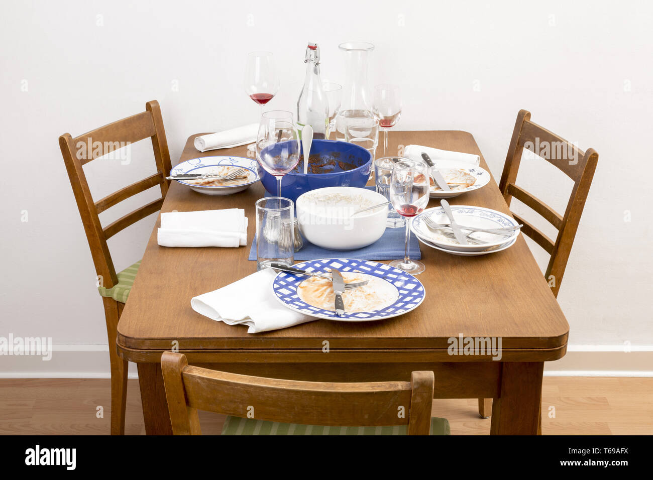 Table with two chairs and dirty dishes on it Stock Photo - Alamy