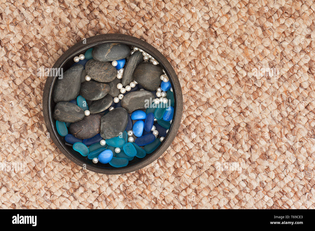 Pearls and colored stones in clay vase on carpet background Stock Photo ...