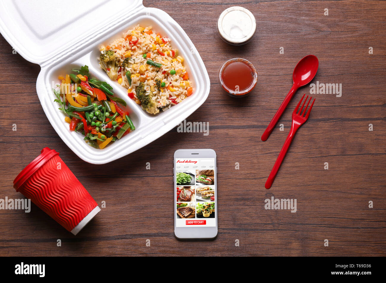 Cell phone with open page of food delivery site on screen and takeout ...
