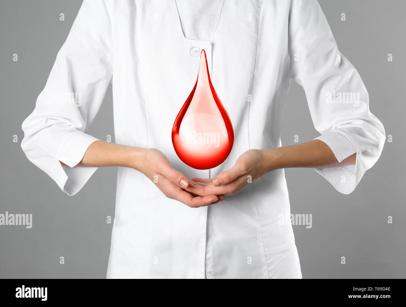 Female doctor with drop of blood on grey background, closeup Stock ...